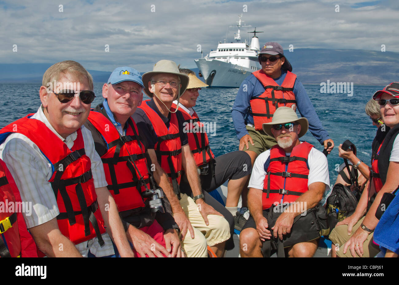 Isabella Island in Galapagos Islands with tourists on zodiac boats with ...