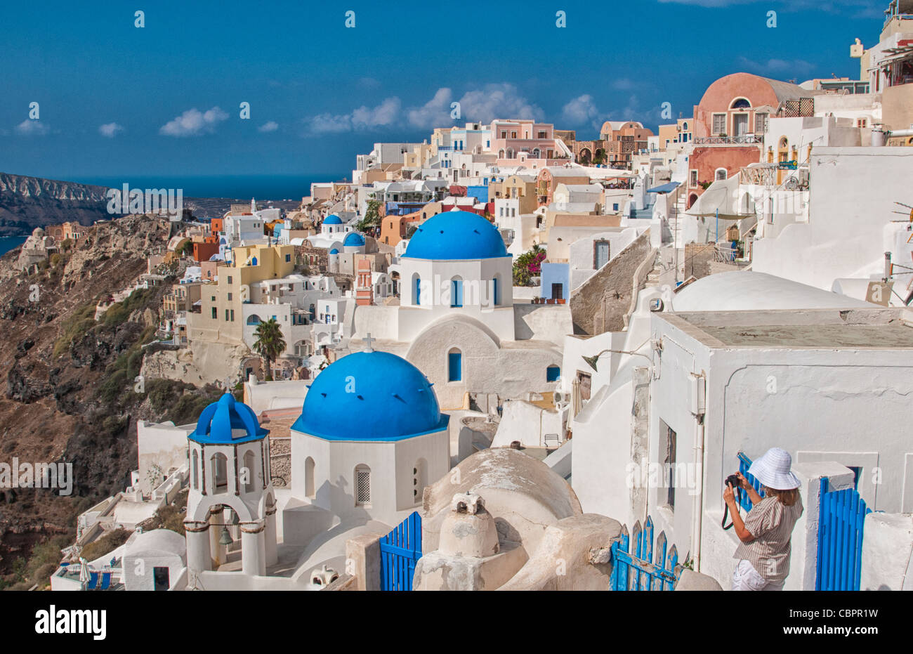 Looking down the steep cliffs of white buildings in beautiful Oia in ...
