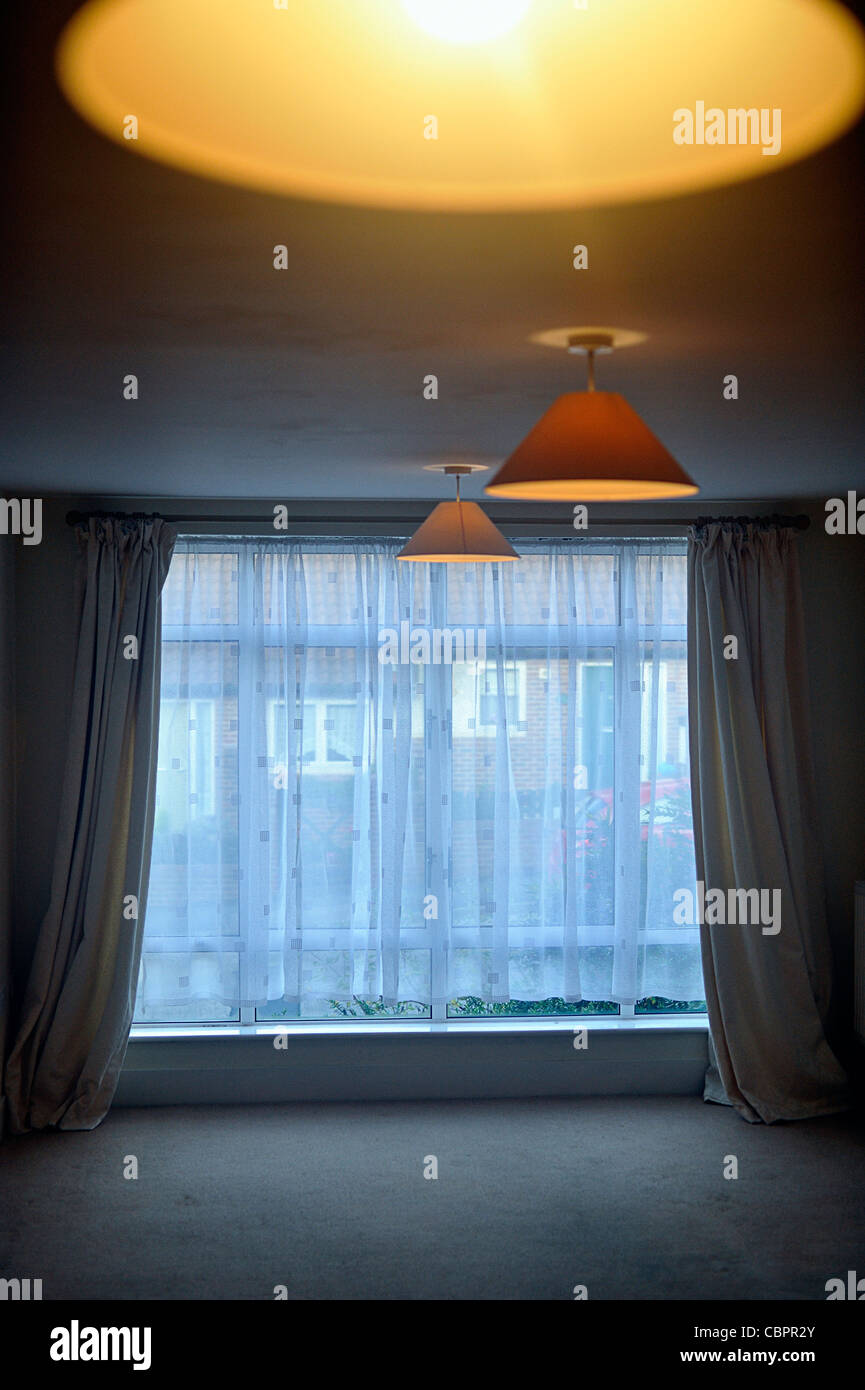 Empty living room with window and lampshades Stock Photo - Alamy