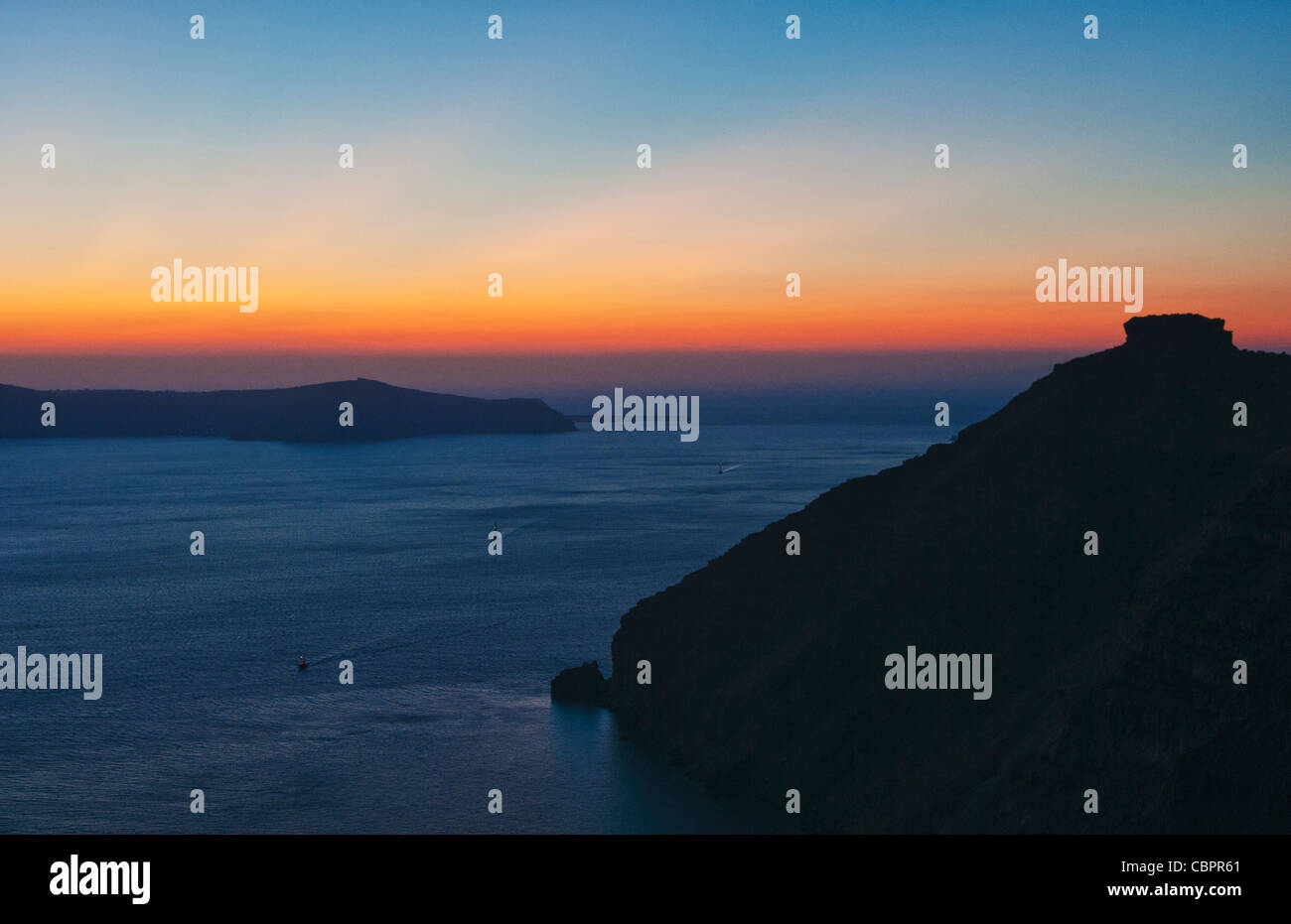 Sunset of Thirassia from Santorini with colorful sky in Greece Greek ...