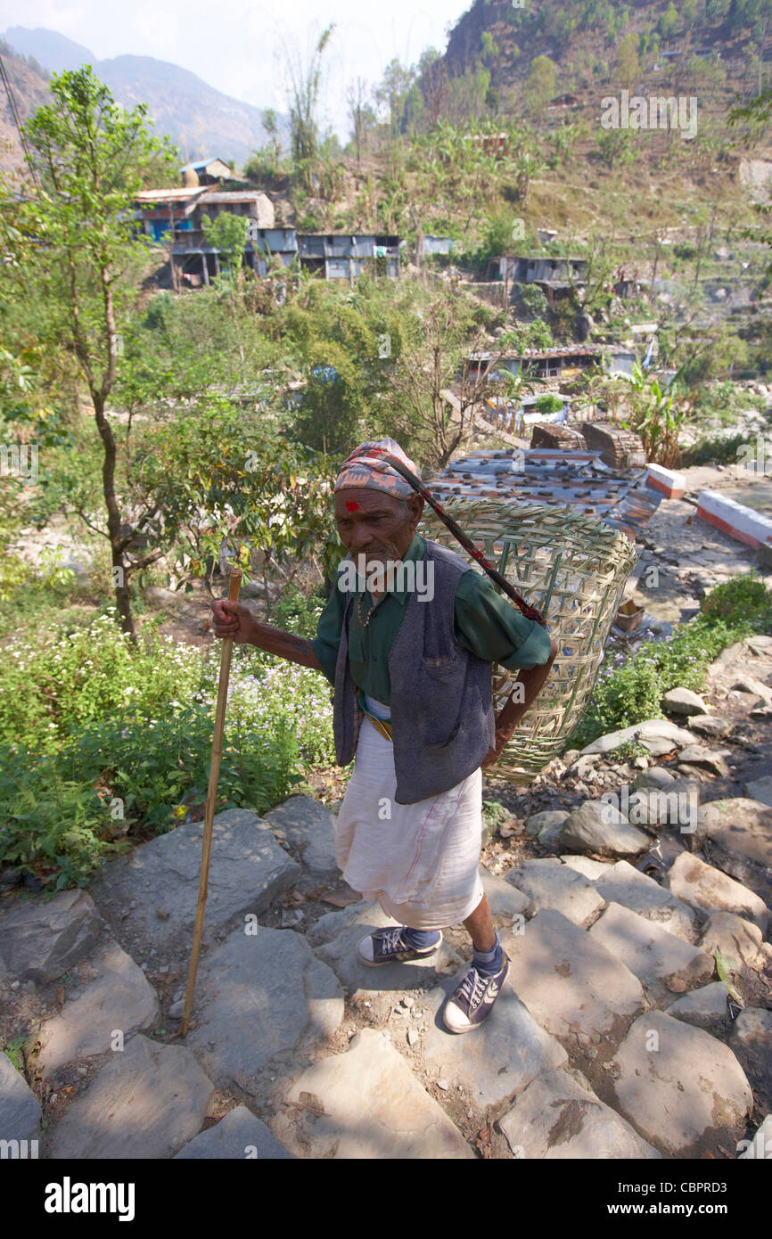 Portrait of an elderly porter carrying a traditional basket on the ...