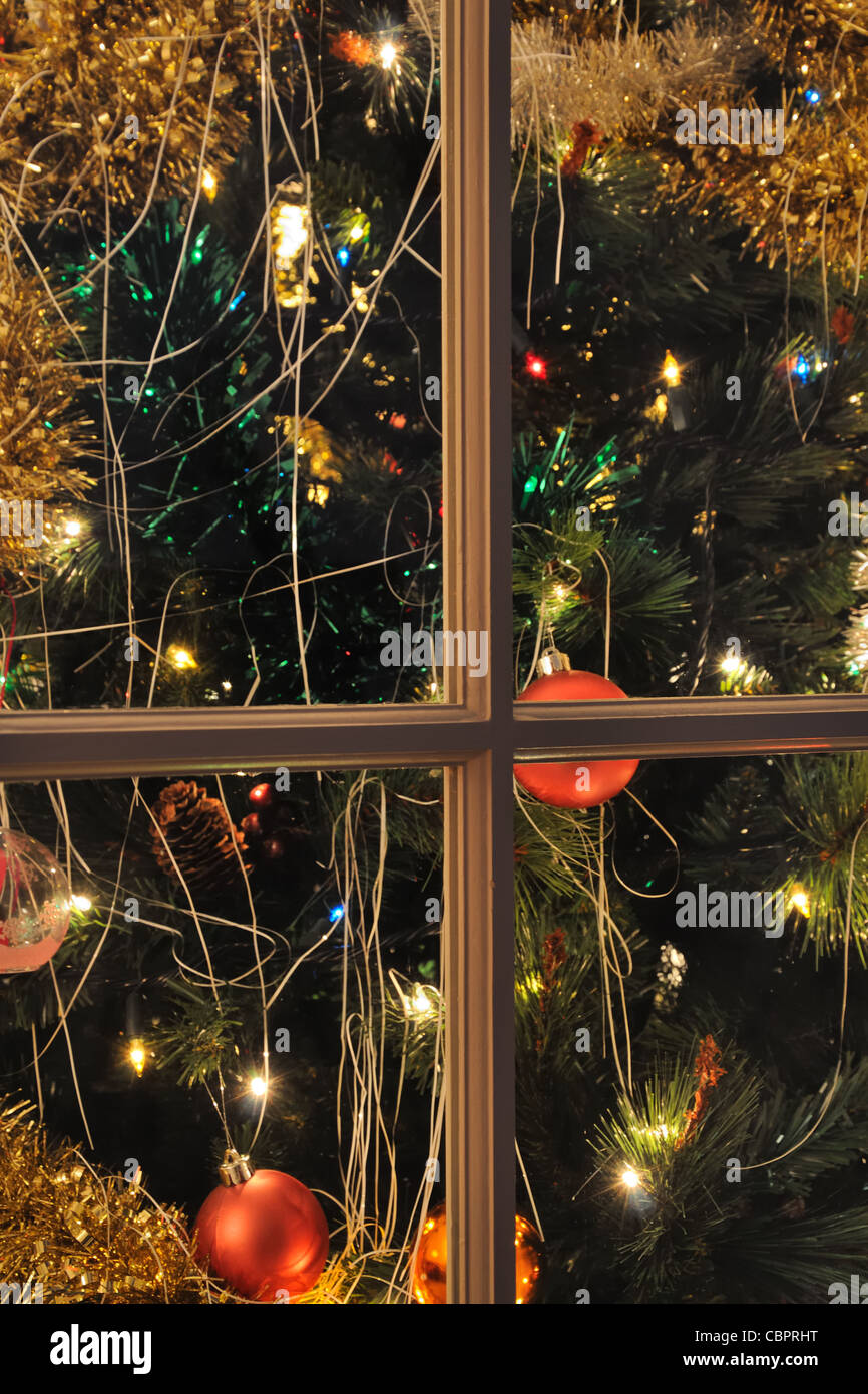 Christmas tree and decorations looking through sash window Stock Photo ...