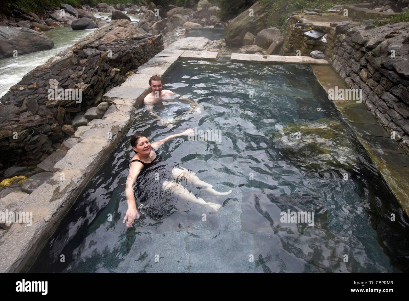 Trekkers relaxing in the hot springs near Chhomrong on the Annapurna ...