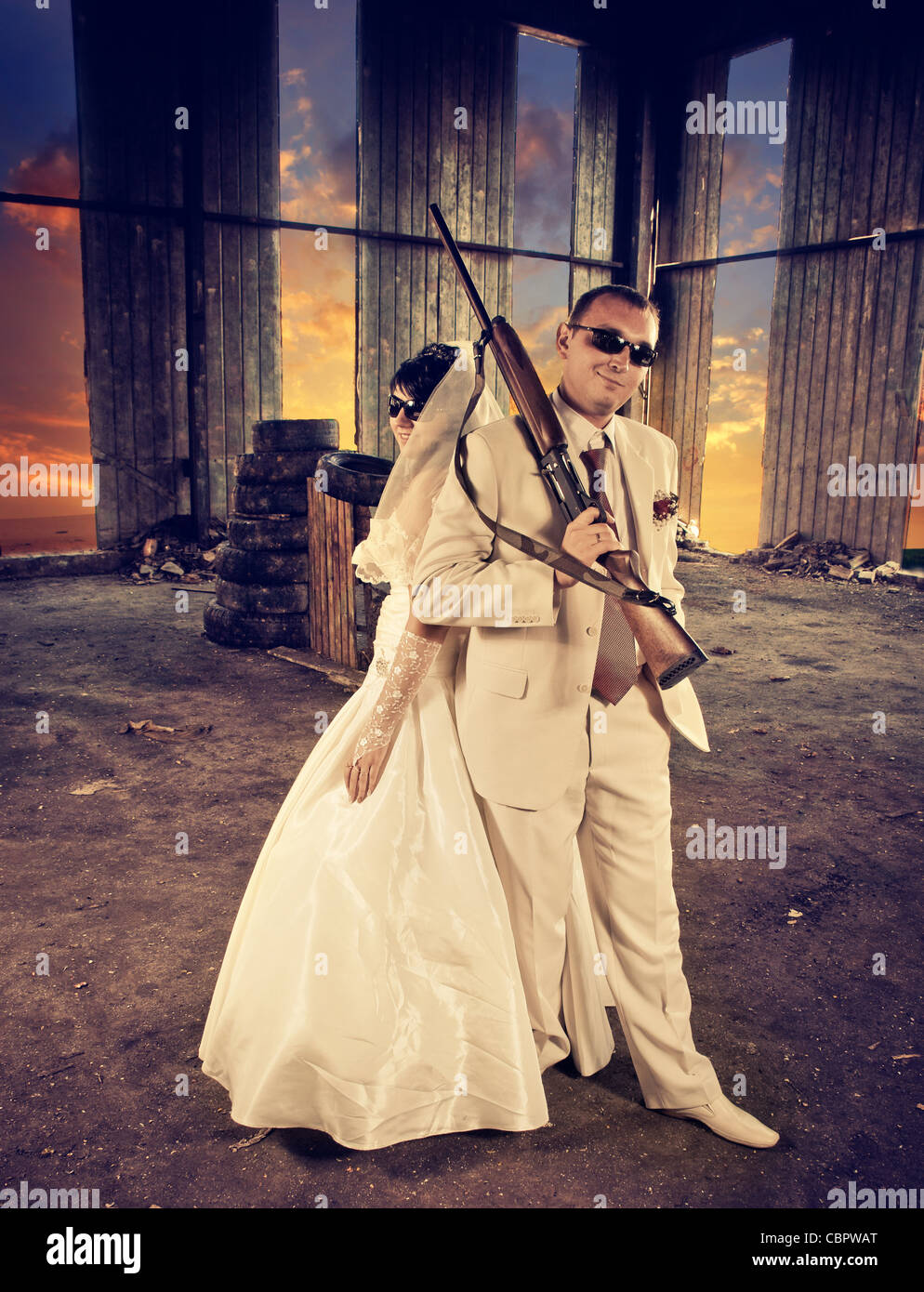 Bride And Groom Poses With Guns
