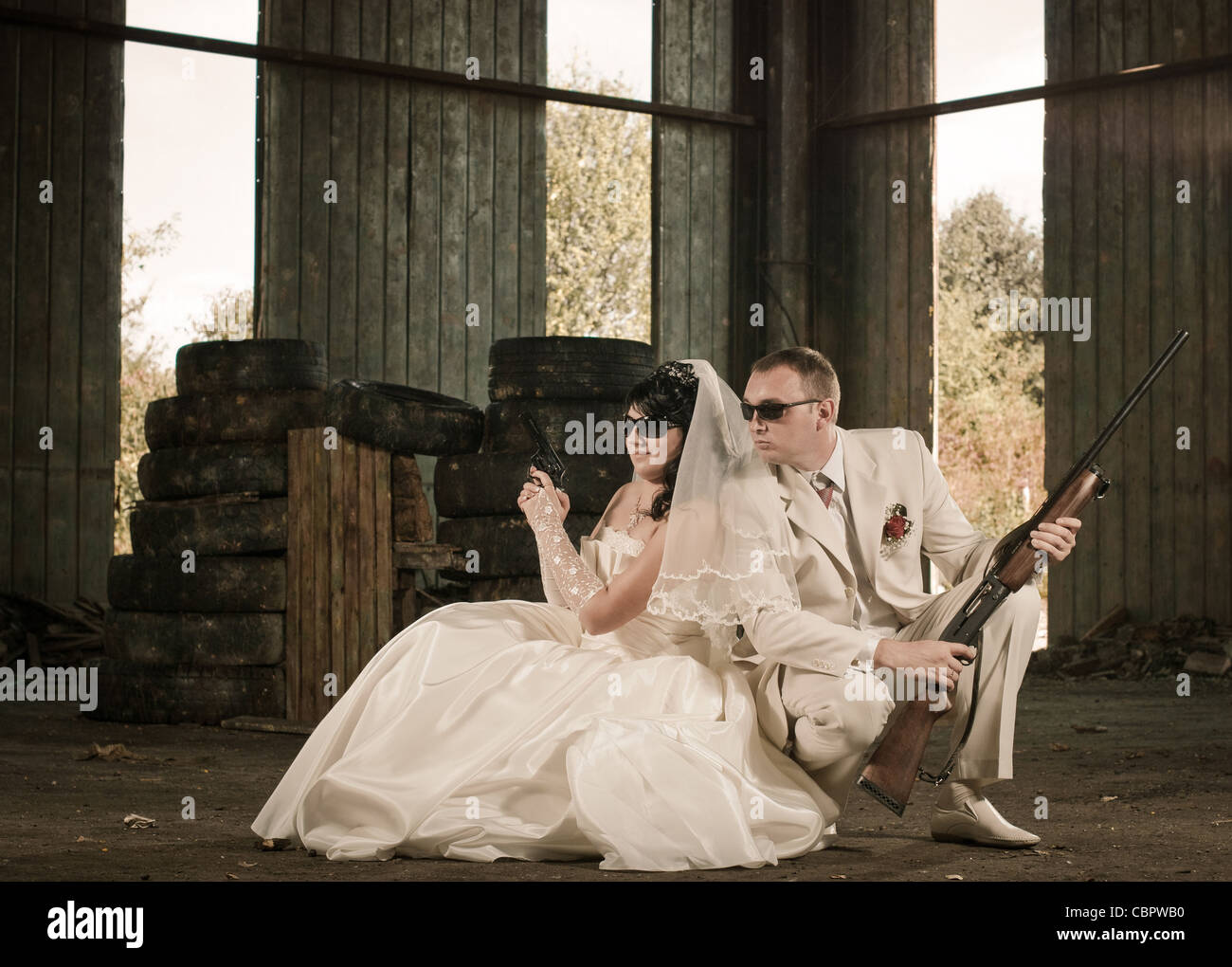 Bride and groom holding guns hi-res stock photography and images - Alamy