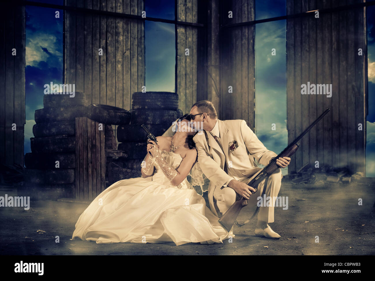 Bride And Groom Poses With Guns