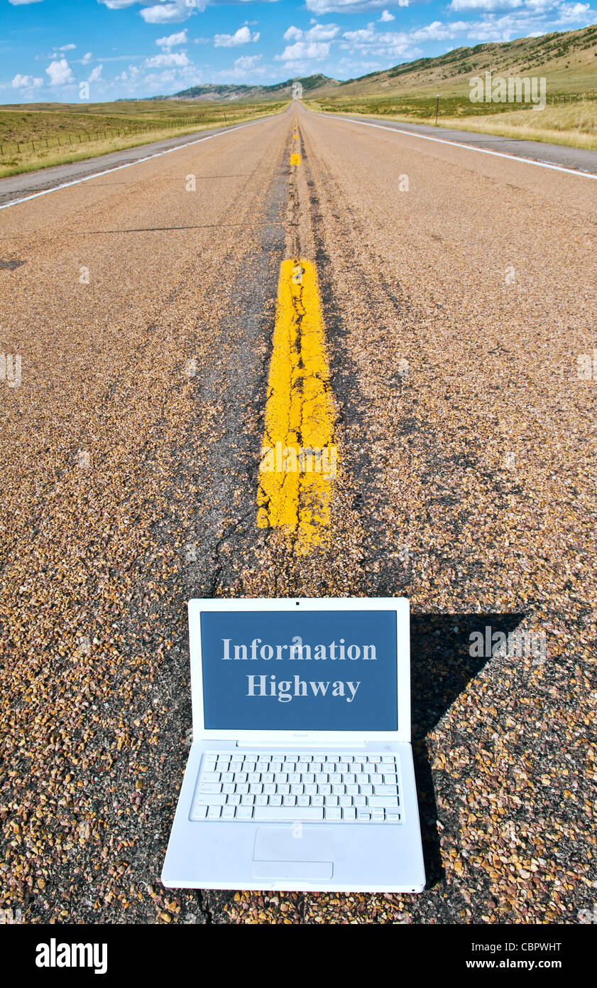 Computer in middle of remote road with Information Highway with ...