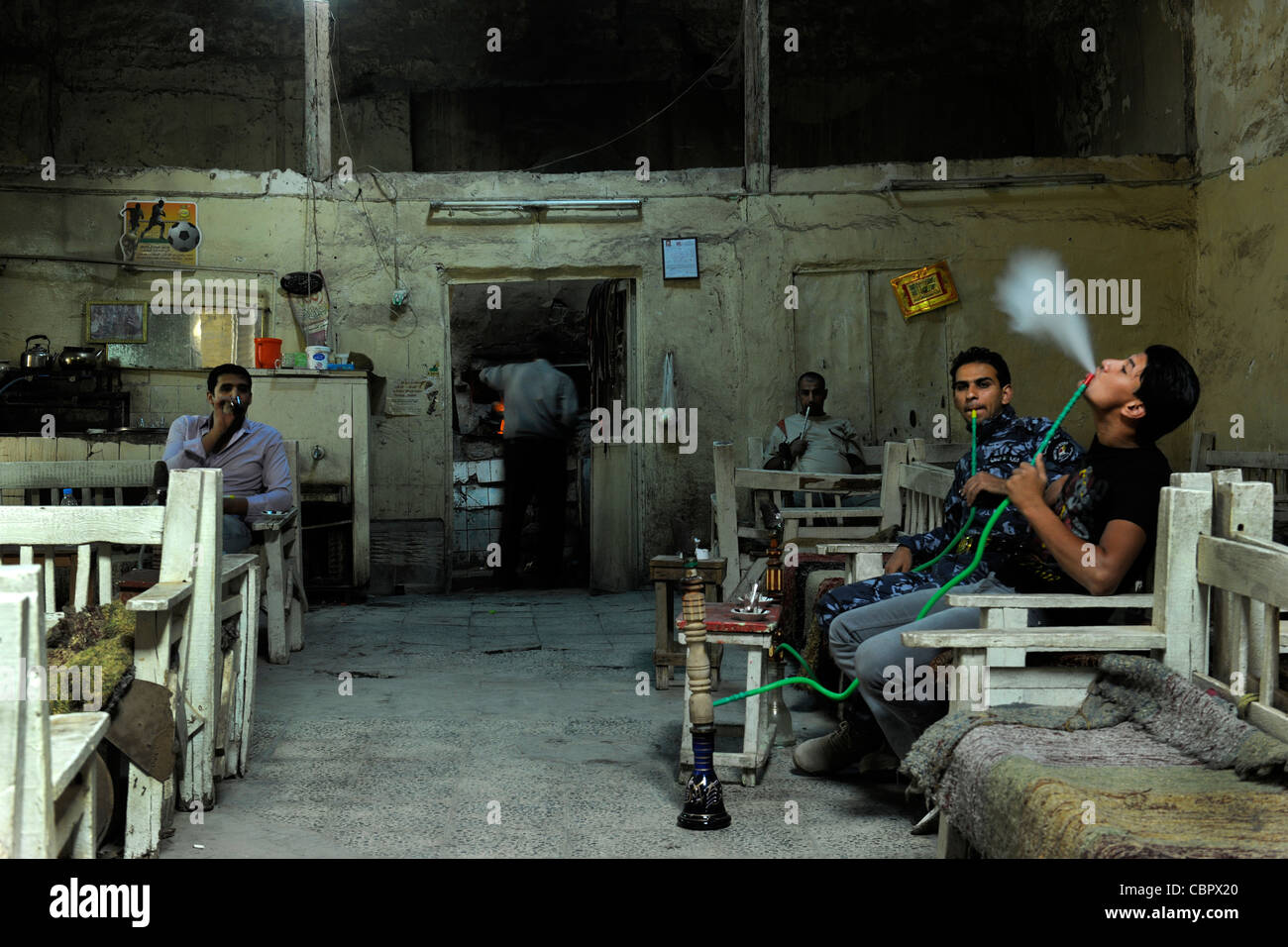 Men smoking a water pipe (shisha) at a tea (chai) house with a 500 year ...