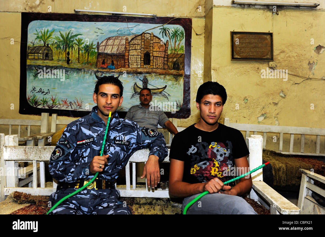Men smoking a water pipe (shisha) at a tea (chai) house with a 500 year ...