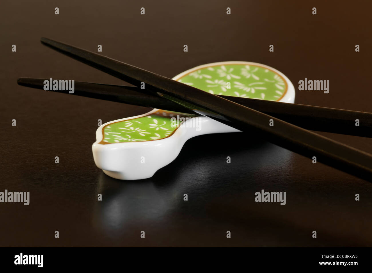 A pair of wooden chopsticks on a colorful rest Stock Photo - Alamy