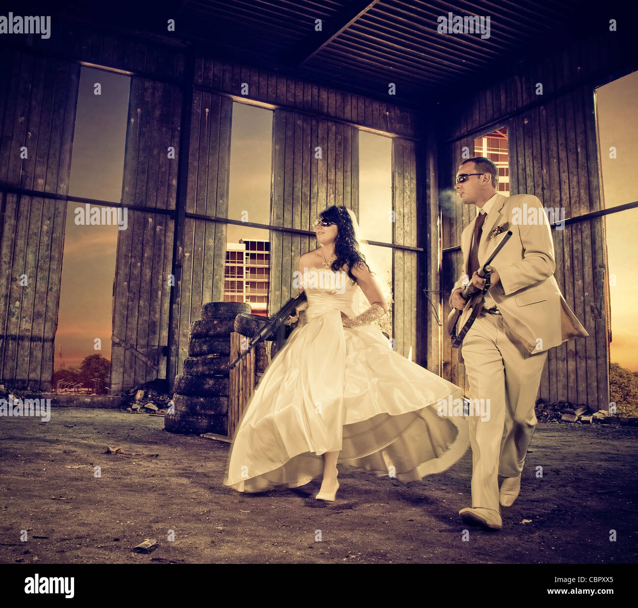 Bride And Groom Poses With Guns