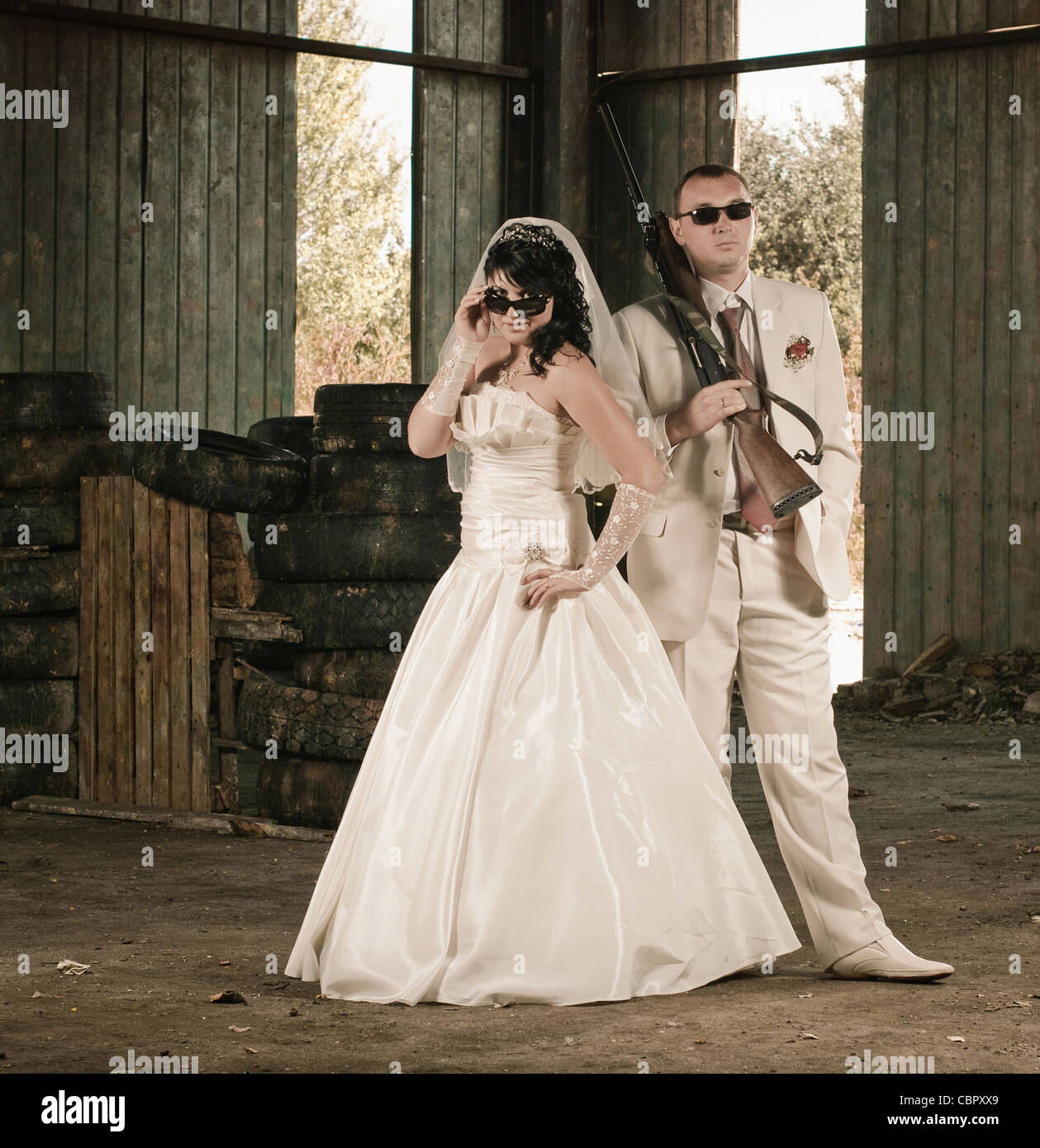 Bride And Groom Poses With Guns