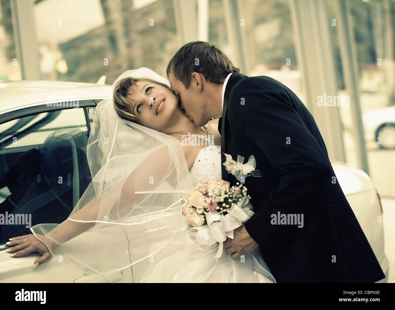 Groom kissing bride Stock Photo - Alamy