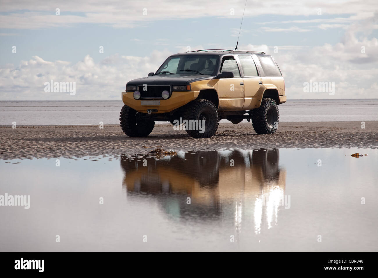 big four-wheel jeep standing beautifully between blue sky and sea water ...