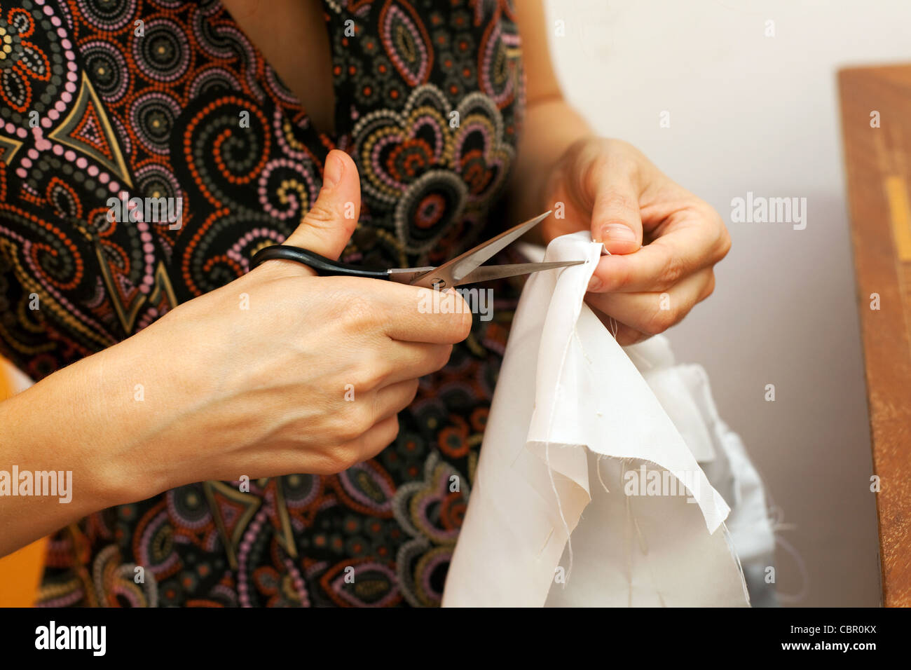 Womans hands cutting fabric Stock Photo - Alamy