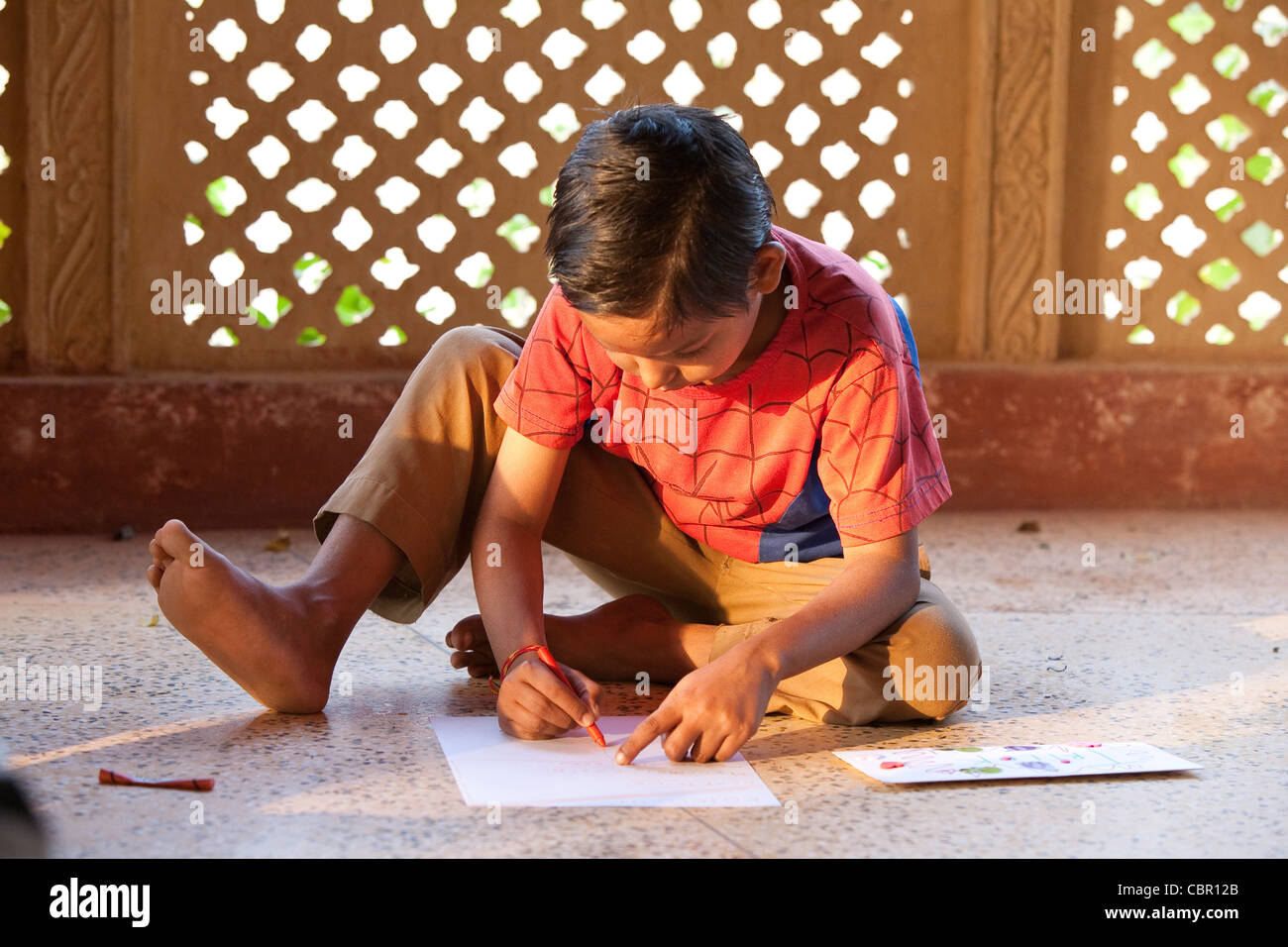 Boy drawing in the Meditation Pavilion - Udayan Campus Stock Photo - Alamy