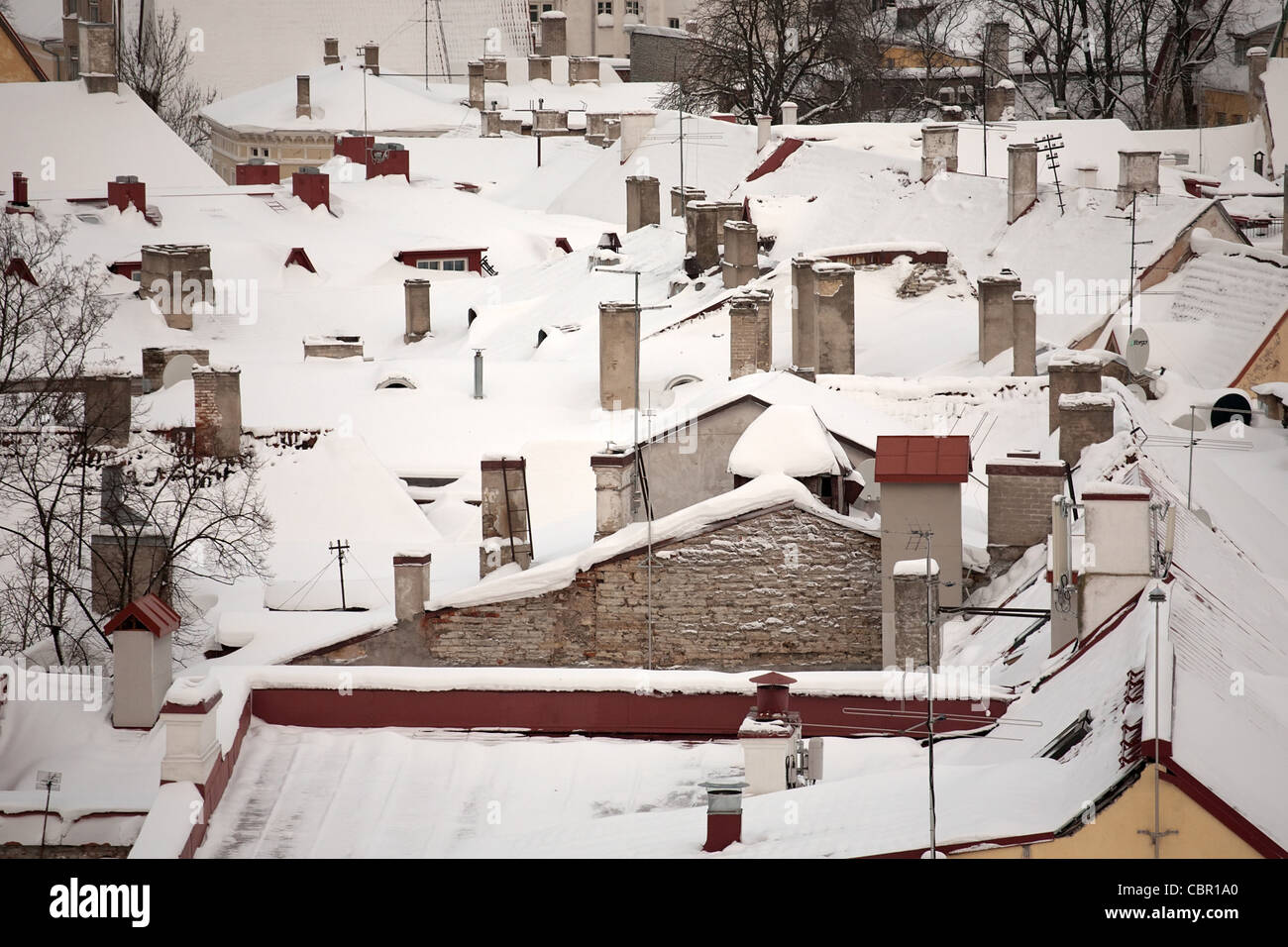 pattern of town roofs covered with snow with chimneys, aerial view ...