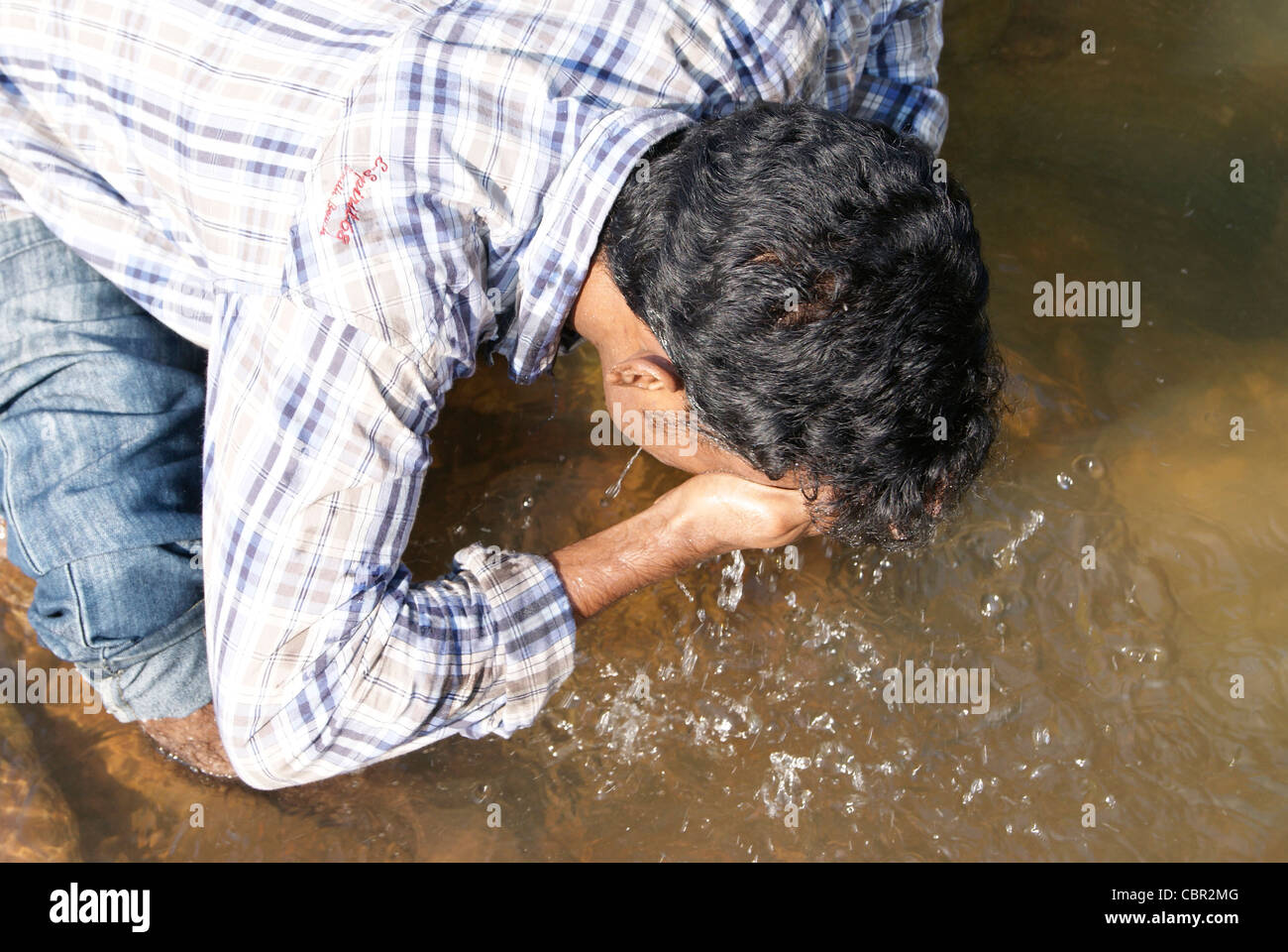 Face Washing in river water Stock Photo - Alamy