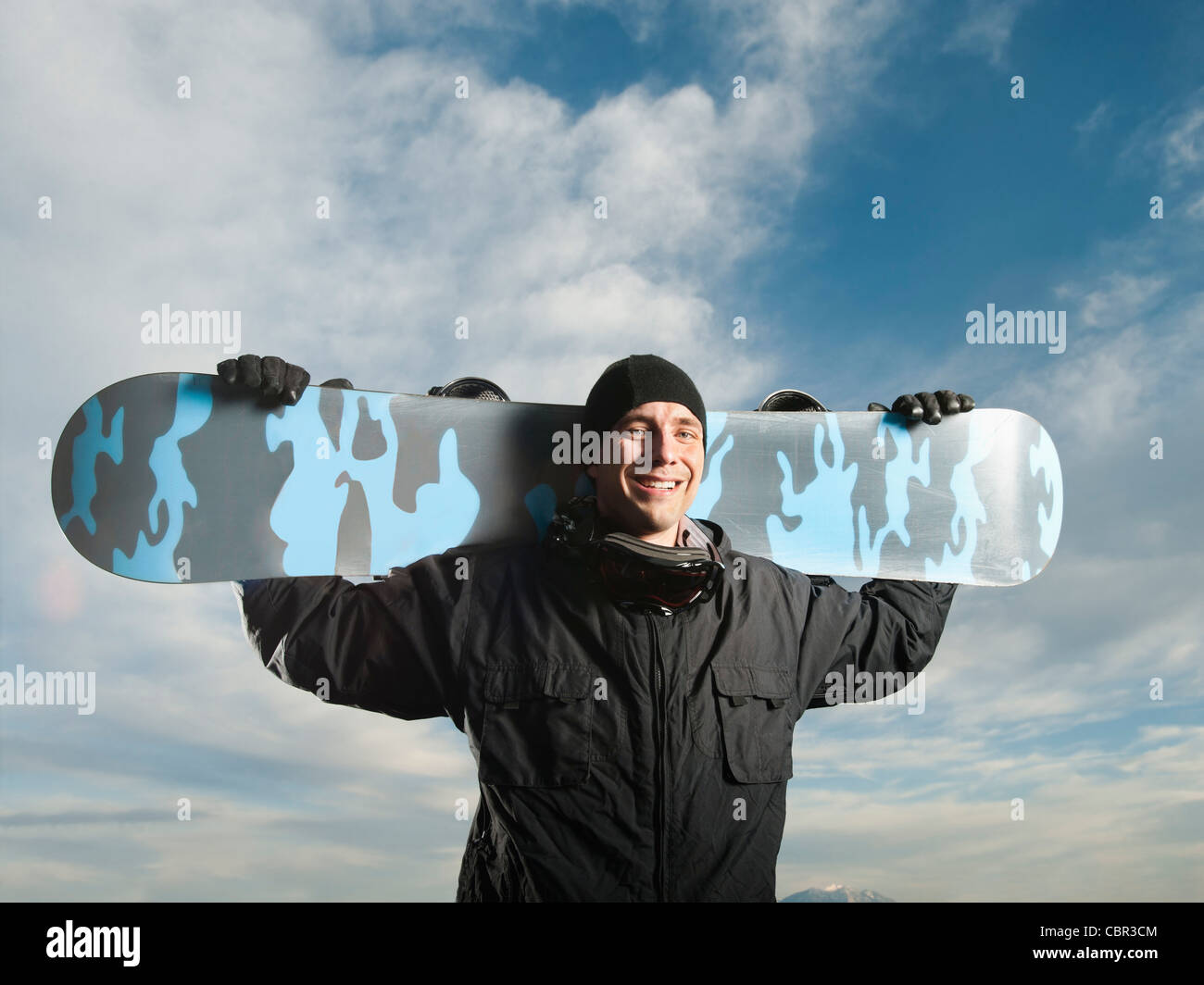 Caucasian man holding snowboard Stock Photo - Alamy