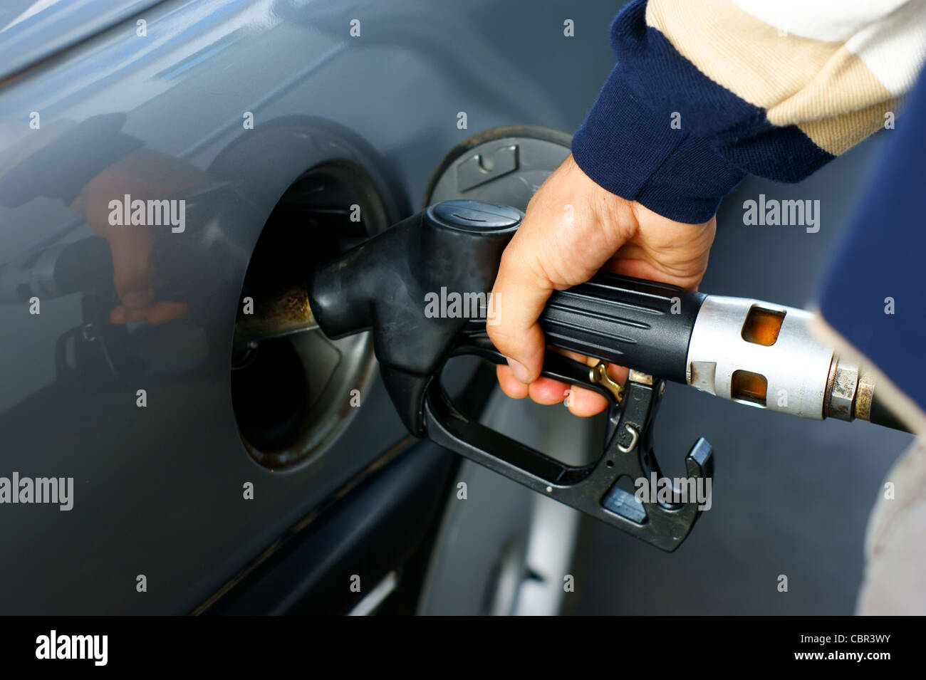 Hand fill up of gasoline Stock Photo - Alamy