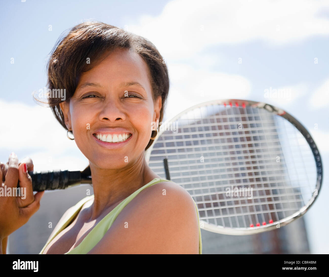 Black woman holding tennis racquet Stock Photo - Alamy