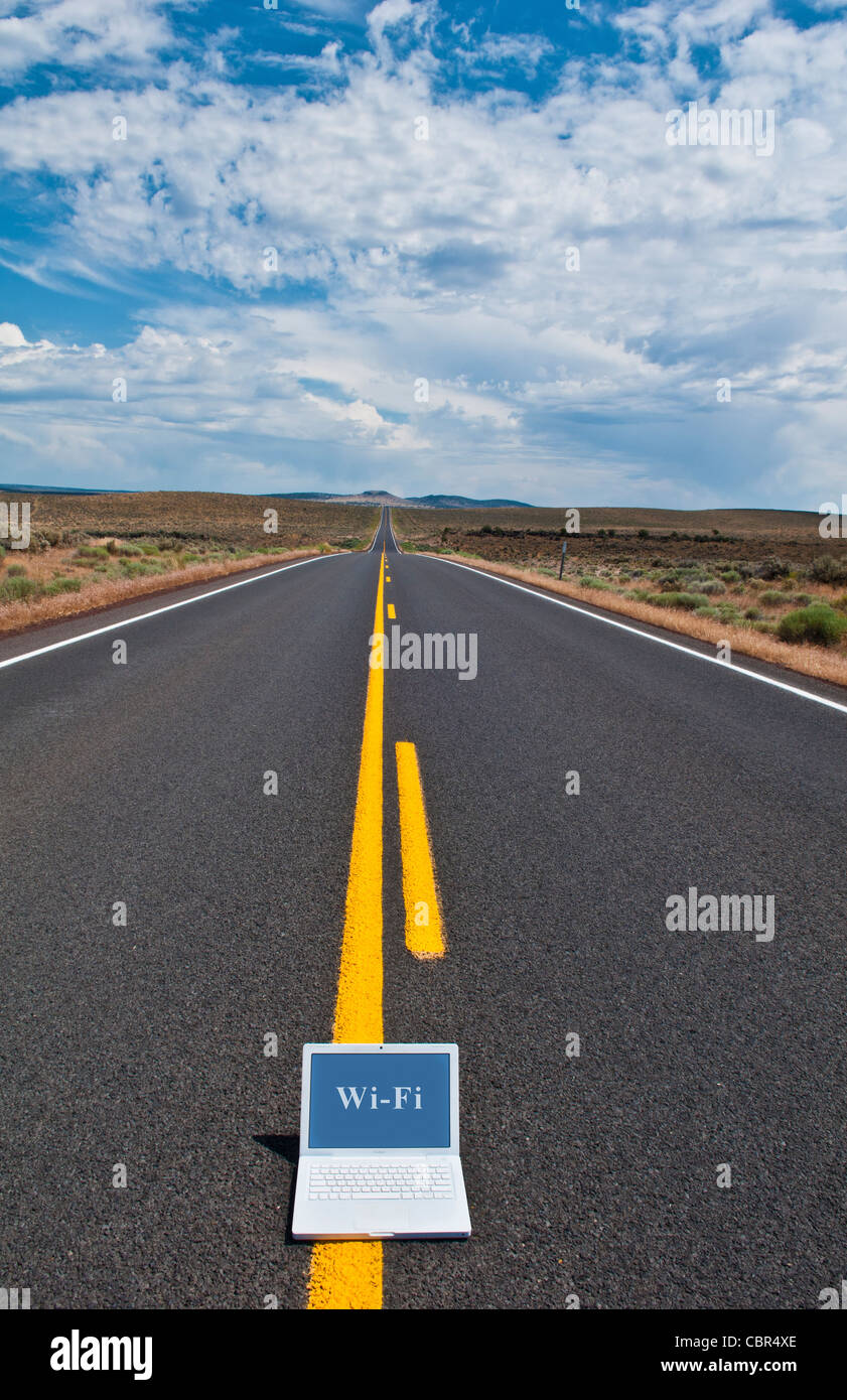 Abstract Information highway with computer in middle of deserted road ...