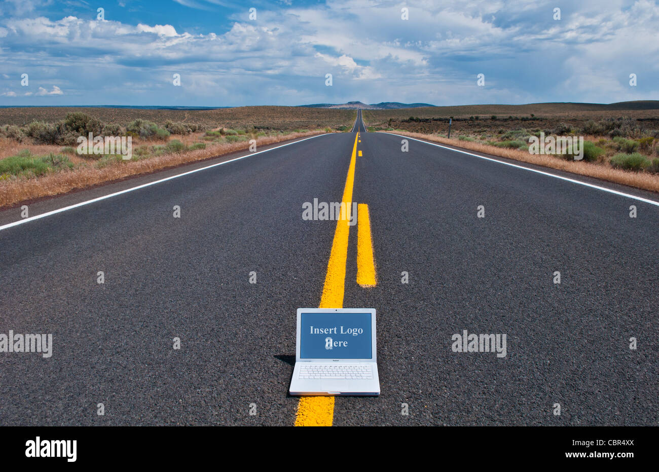 Abstract Information highway with computer in middle of deserted road ...