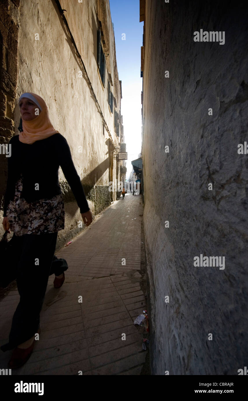 Muslim girl walks down an alley in Essaouira, western Morocco Stock ...