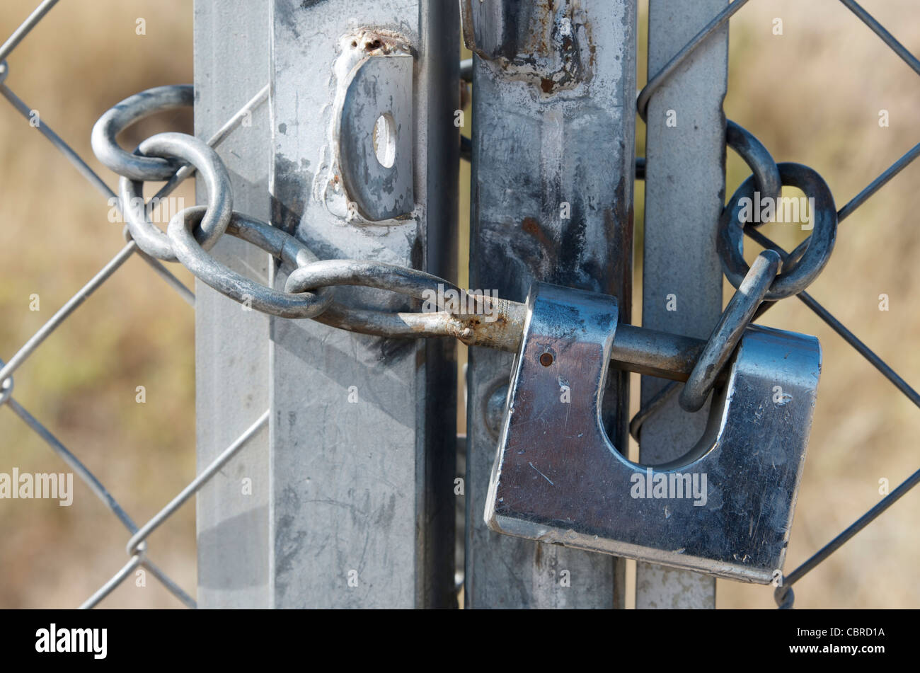 padlock and chain on a metal fence Stock Photo - Alamy