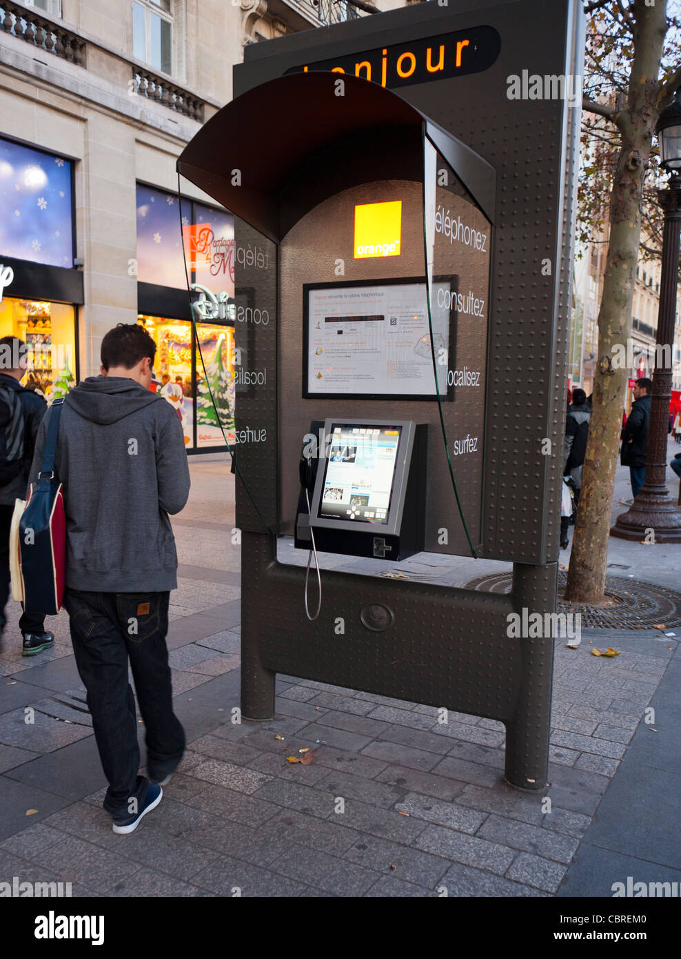 Lifestyle rear young adults public telephone box hi-res stock ...