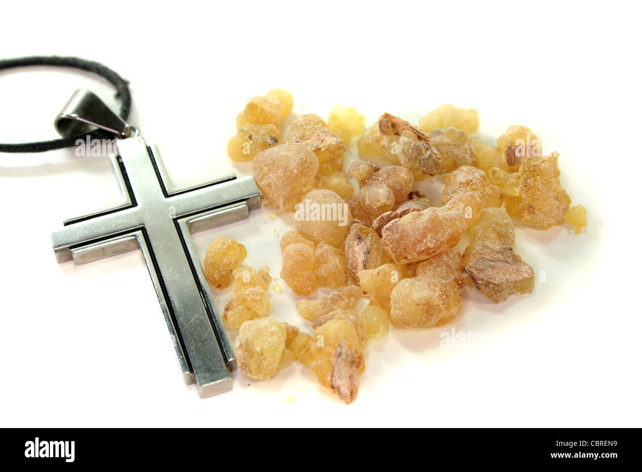 a pile of yellow incense with cross on a white background Stock Photo ...