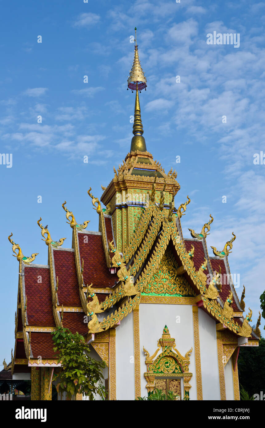 Buddhist temple with golden spire and large chofa decorating roof in ...