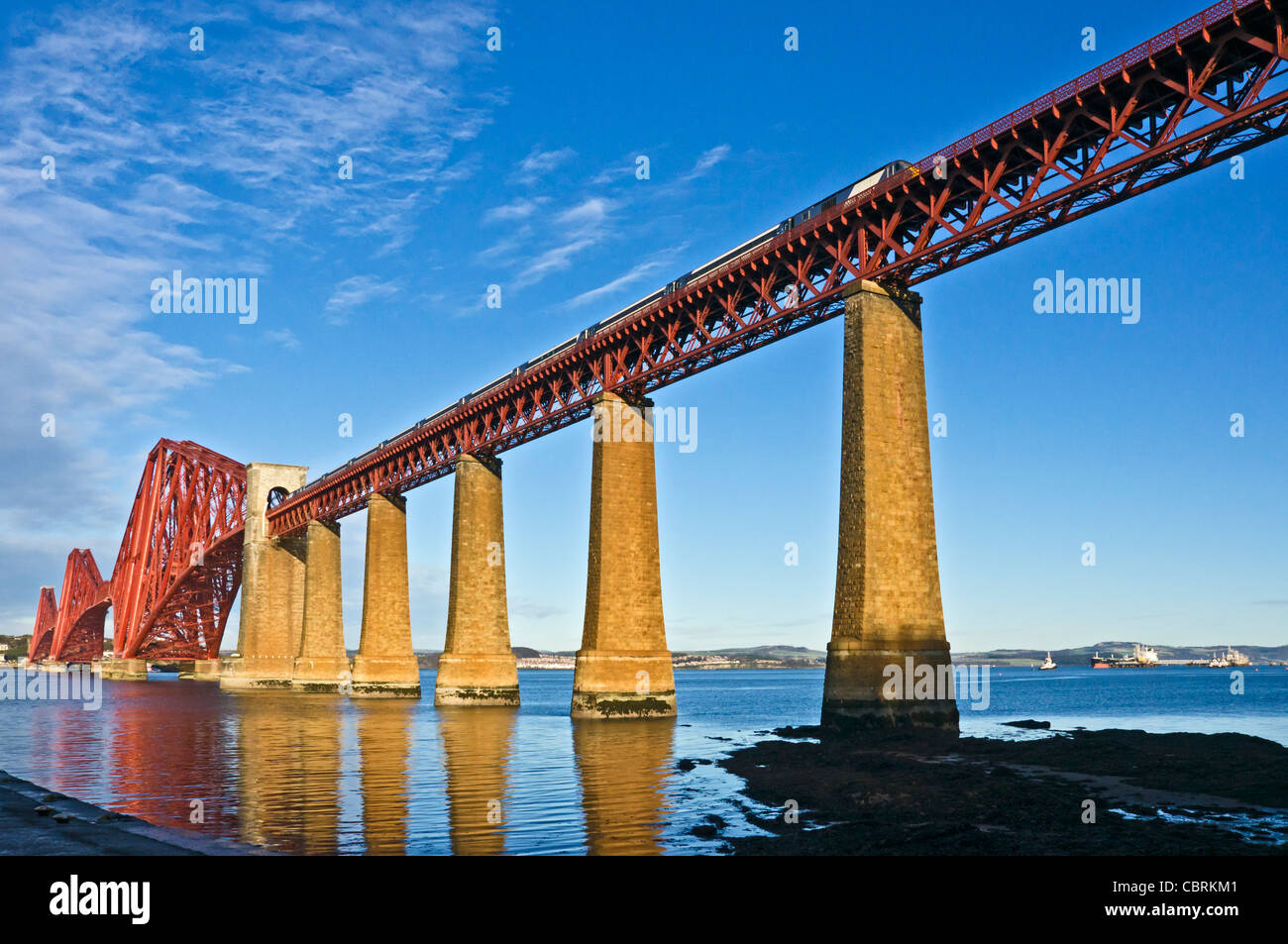 Newly painted Forth Rail Bridge with high speed train passing as seen ...
