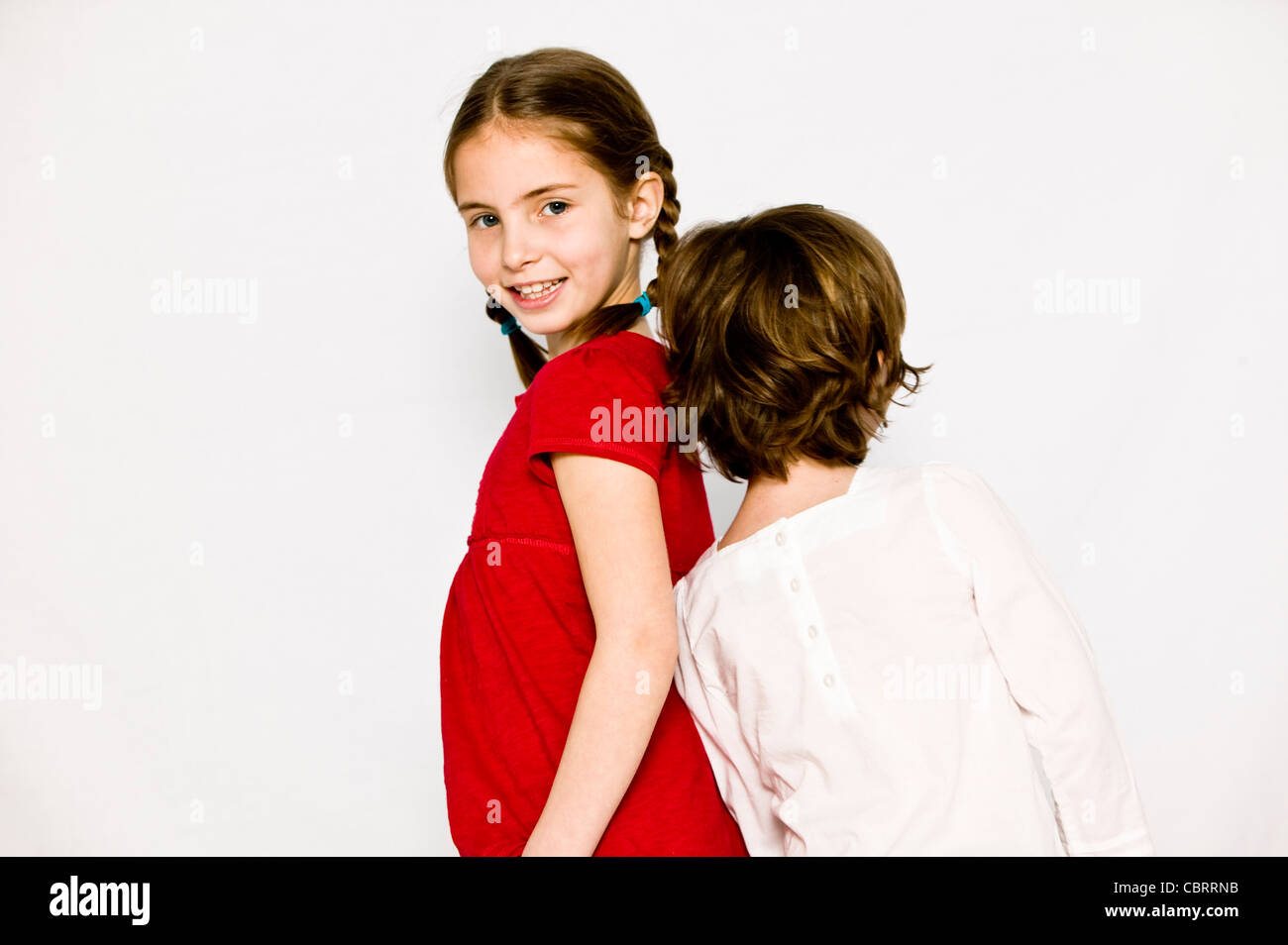 Two sisters, back to back Stock Photo - Alamy