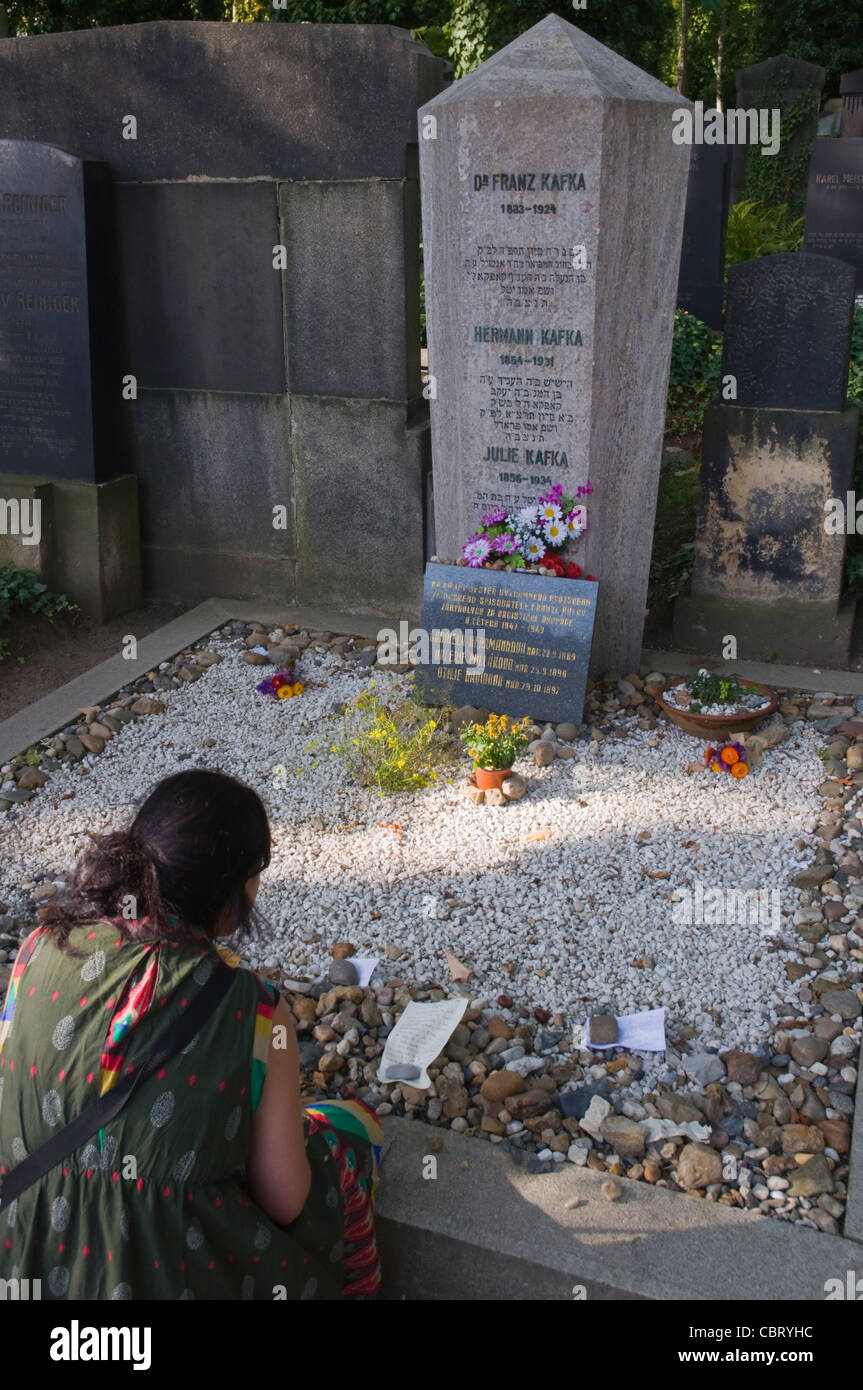 Tourist at grave of Franz Kafka and his family the New Jewish cemetery ...