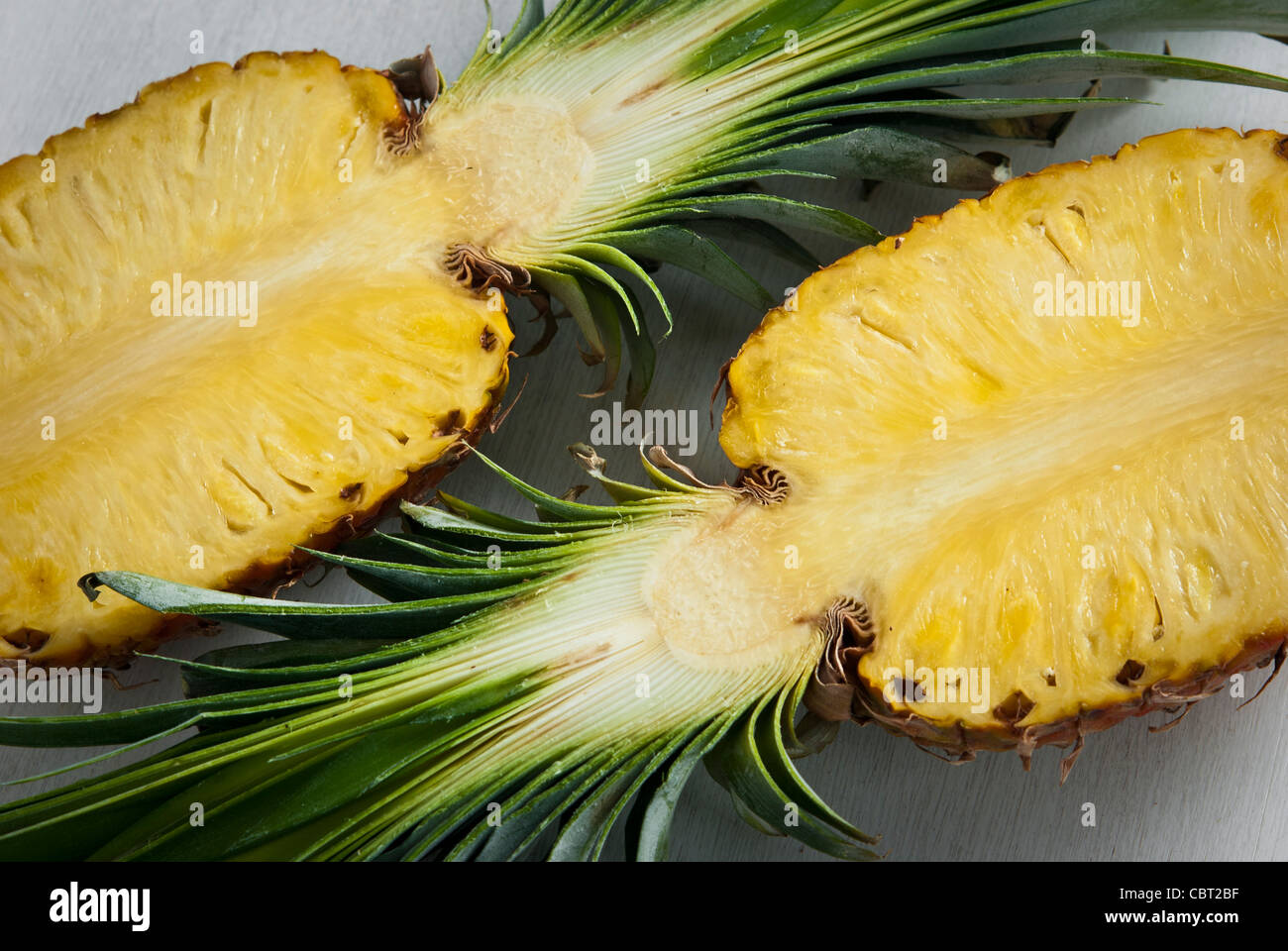 Pineapple cut in half on white background Stock Photo - Alamy