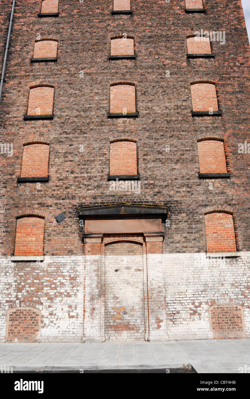 Bricked up windows in old warehouses in Liverpool dock area Stock Photo ...