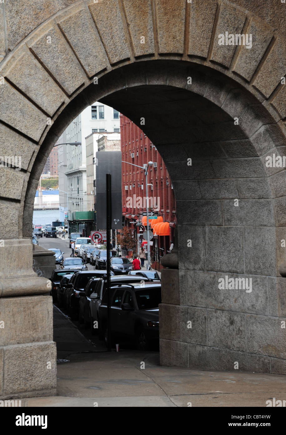 View through sidewalk arch Manhattan Bridge Overpass support tower ...