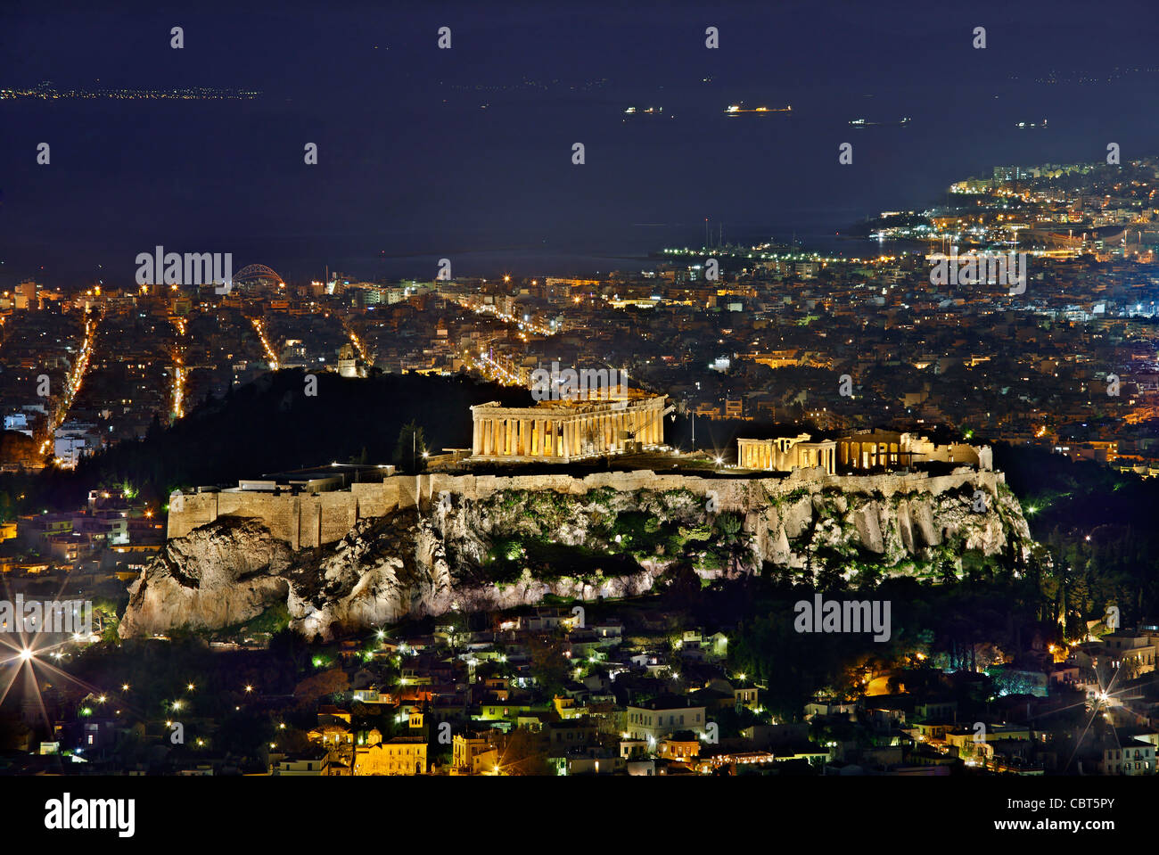 The Acropolis of Athens at night. View from Lycabettus hill. View all the way down to Piraeus ...