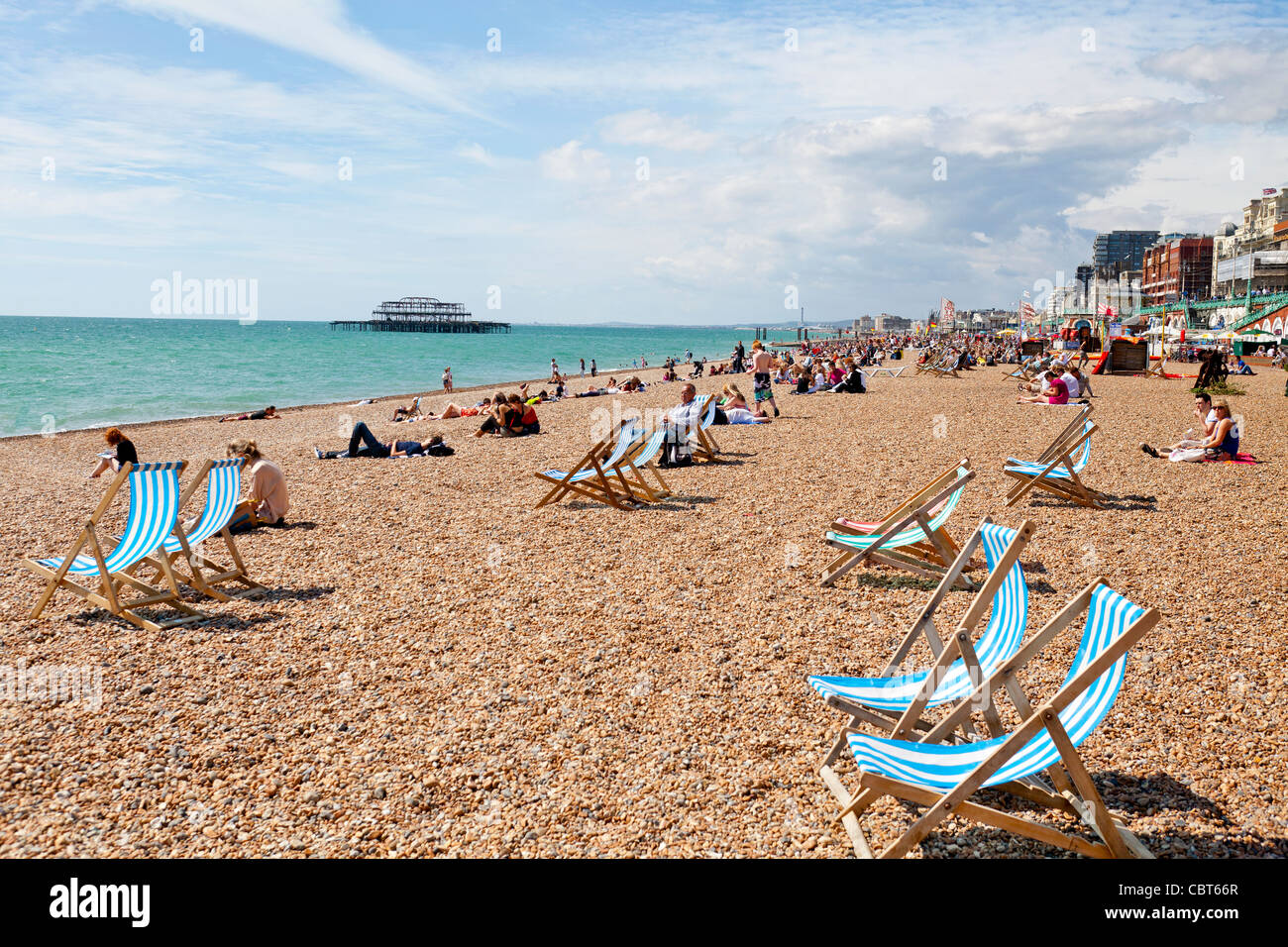 Sun bathers and swimmers relaxing on the ocean beach in Brighton ...