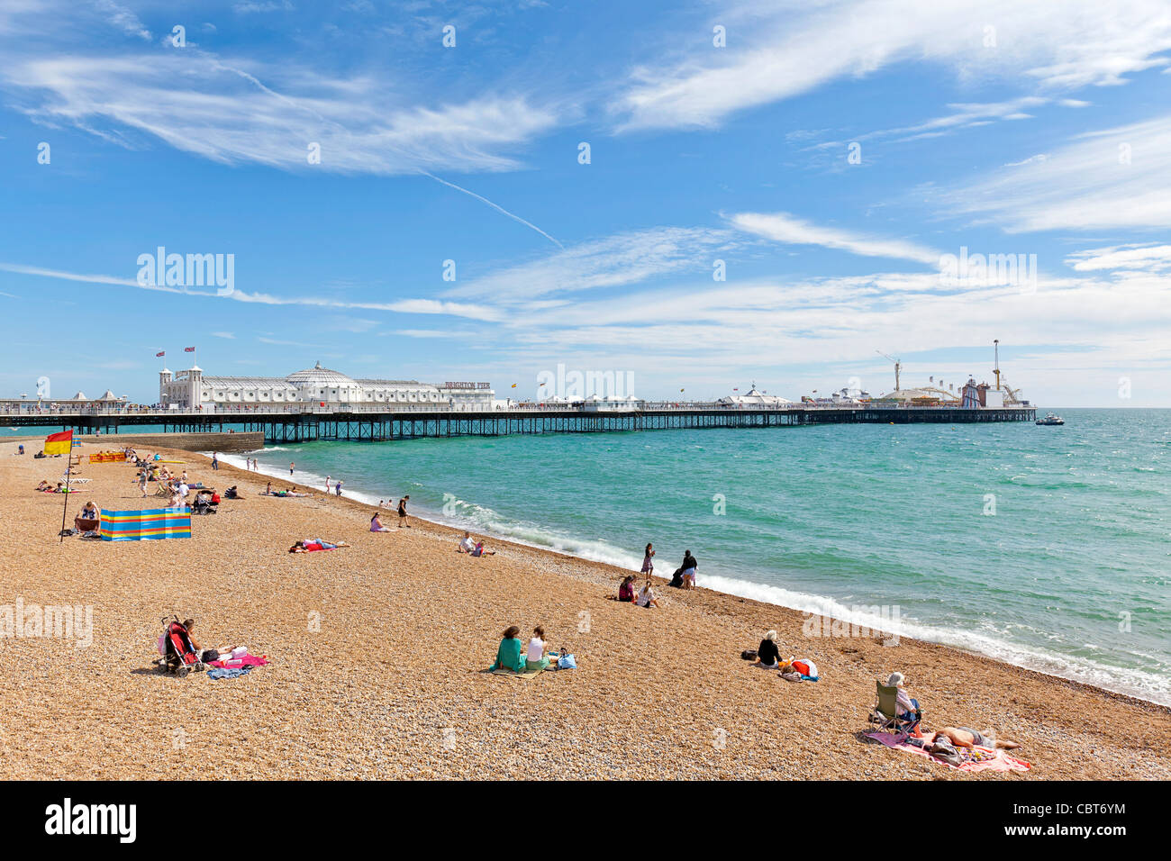 Sun bathers and swimmers relaxing on the ocean beach in Brighton ...