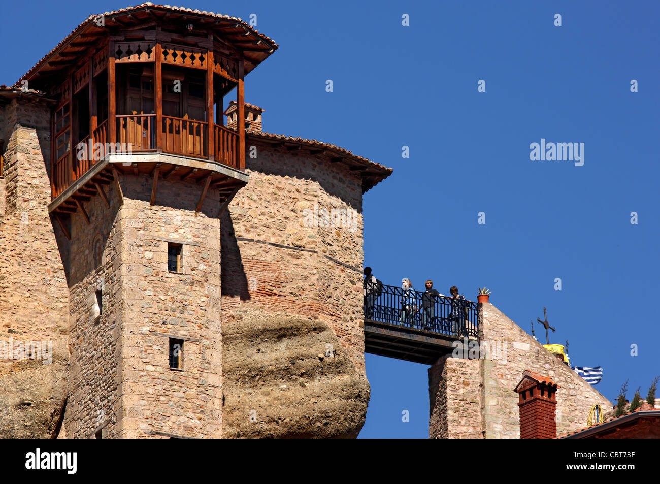 Children crossing the small bridge that connects Roussanou monastery ...