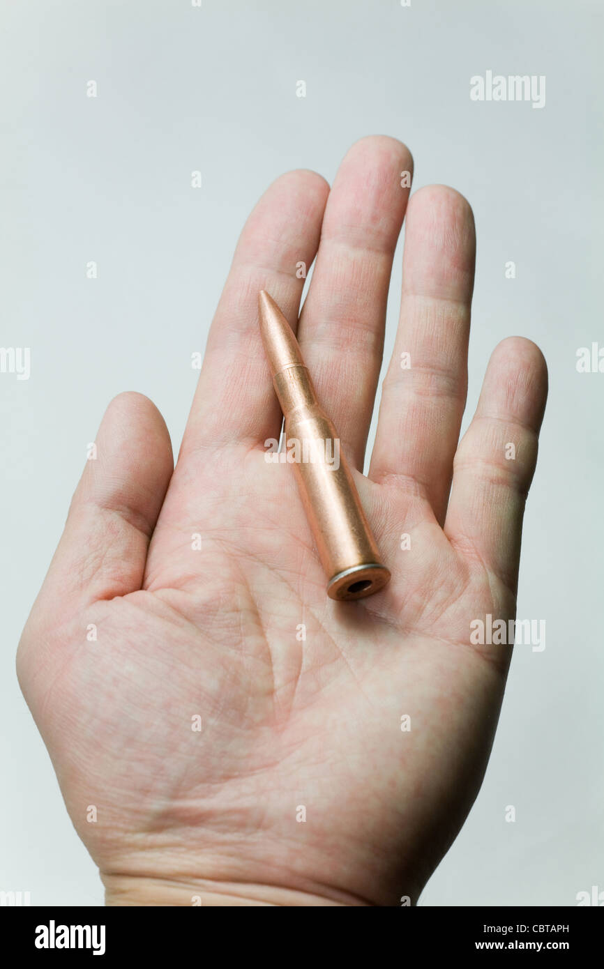 Hand holding rifle bullet concept hi-res stock photography and images ...