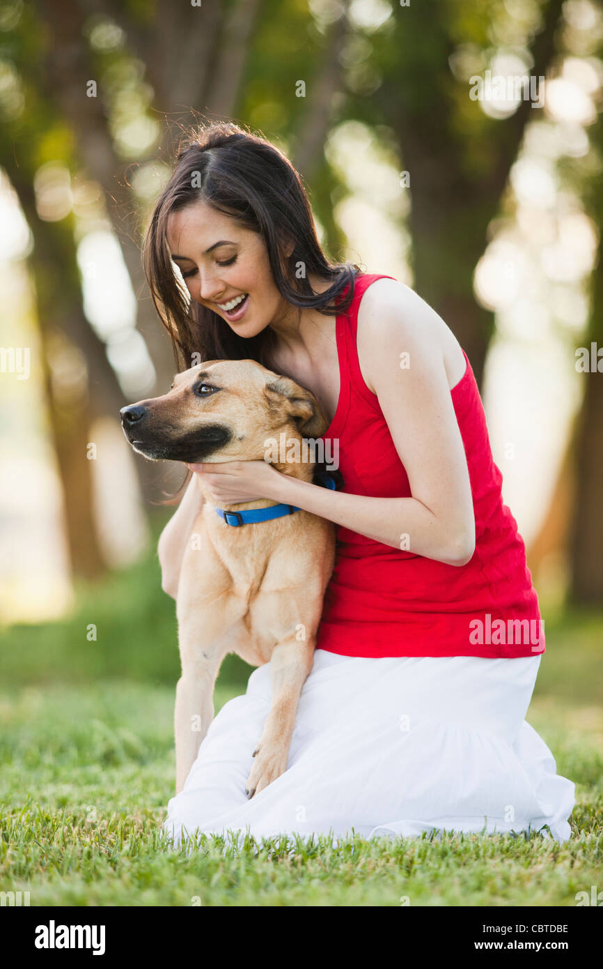 Caucasian woman petting dog Stock Photo - Alamy