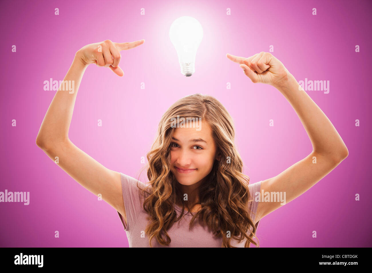 Caucasian teenager pointing at light bulb over her head Stock Photo - Alamy