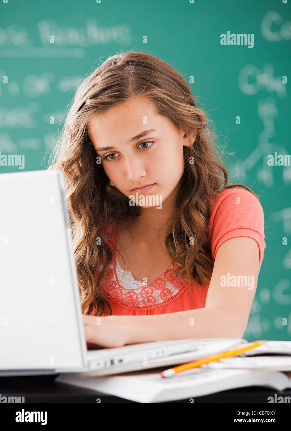 Caucasian teenager using laptop in classroom Stock Photo - Alamy