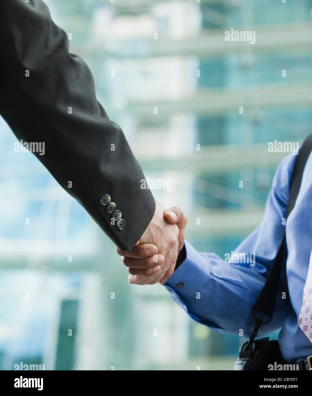 Two multicultural businessmen handshaking hi-res stock photography and ...