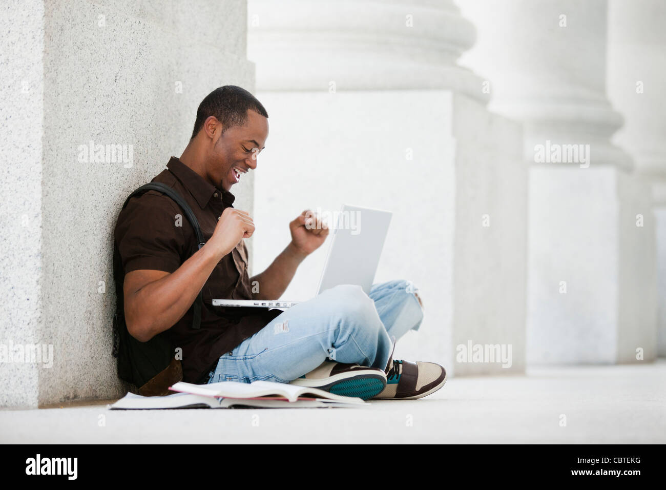 Black college student using laptop outdoors Stock Photo - Alamy
