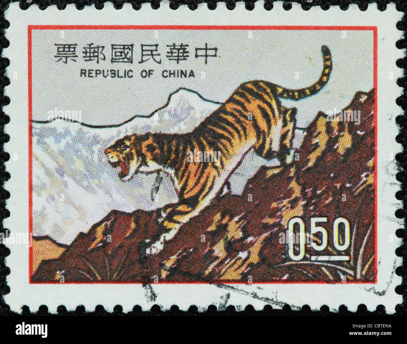 CHINA - A tiger on an old and canceled postage stamp printed in China ...
