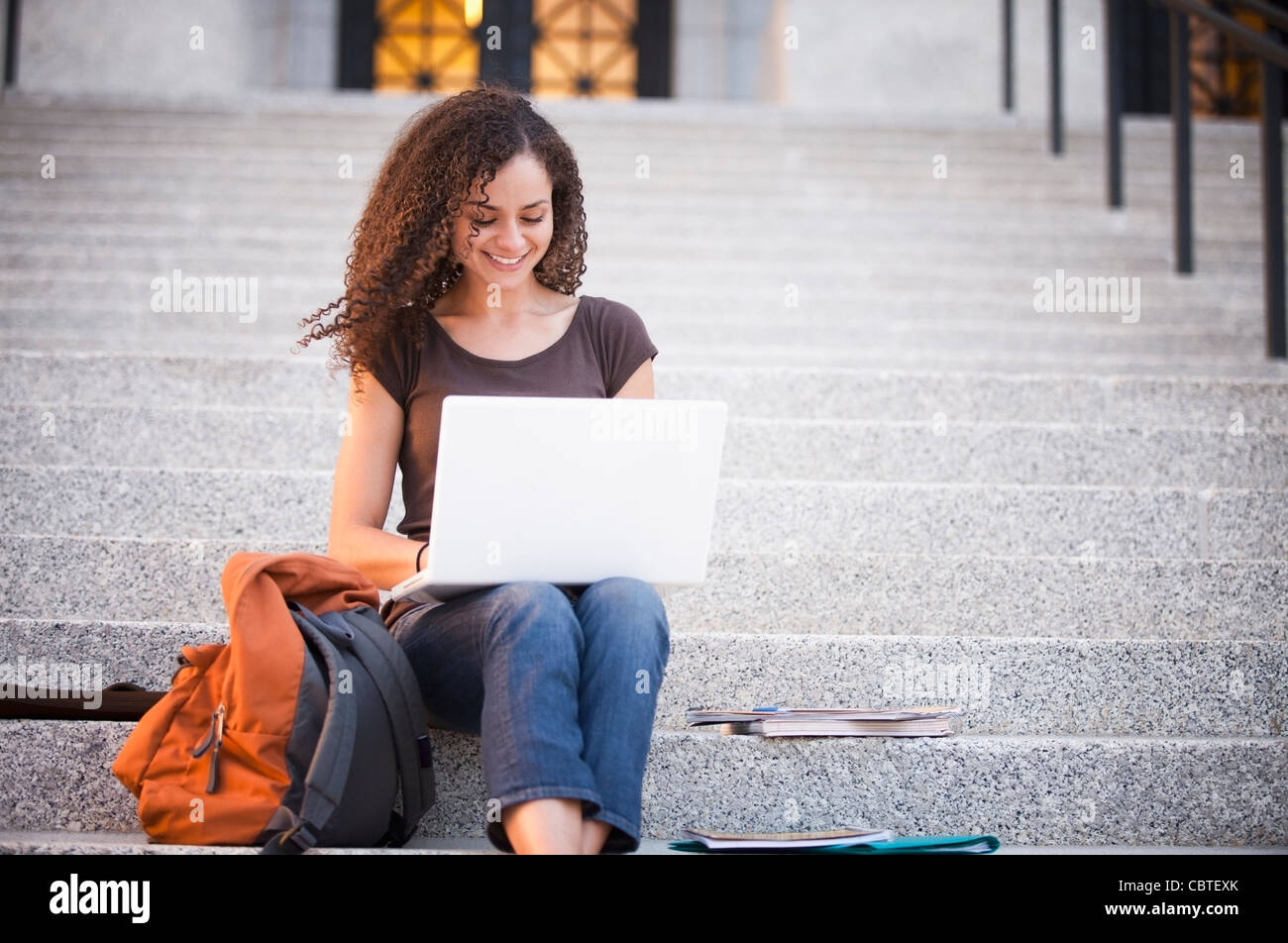 Caucasian college student using laptop outdoors Stock Photo - Alamy